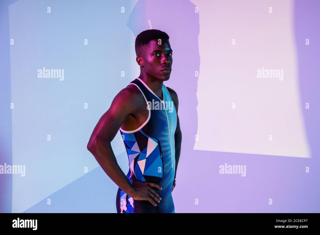 Full body side view of energetic young African American male sprinter ...