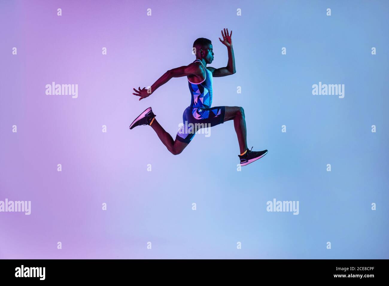 Full body side view of energetic young African American male sprinter ...