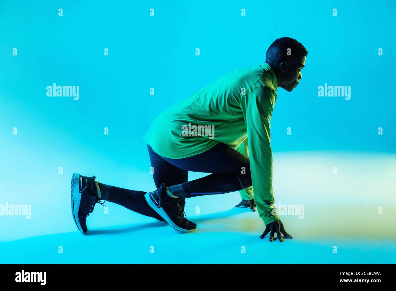 Full body side view of young African American male athlete in trendy ...