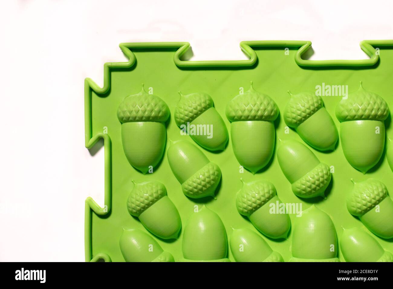 Green orthopedic mat in the form of acorns on a white background ...