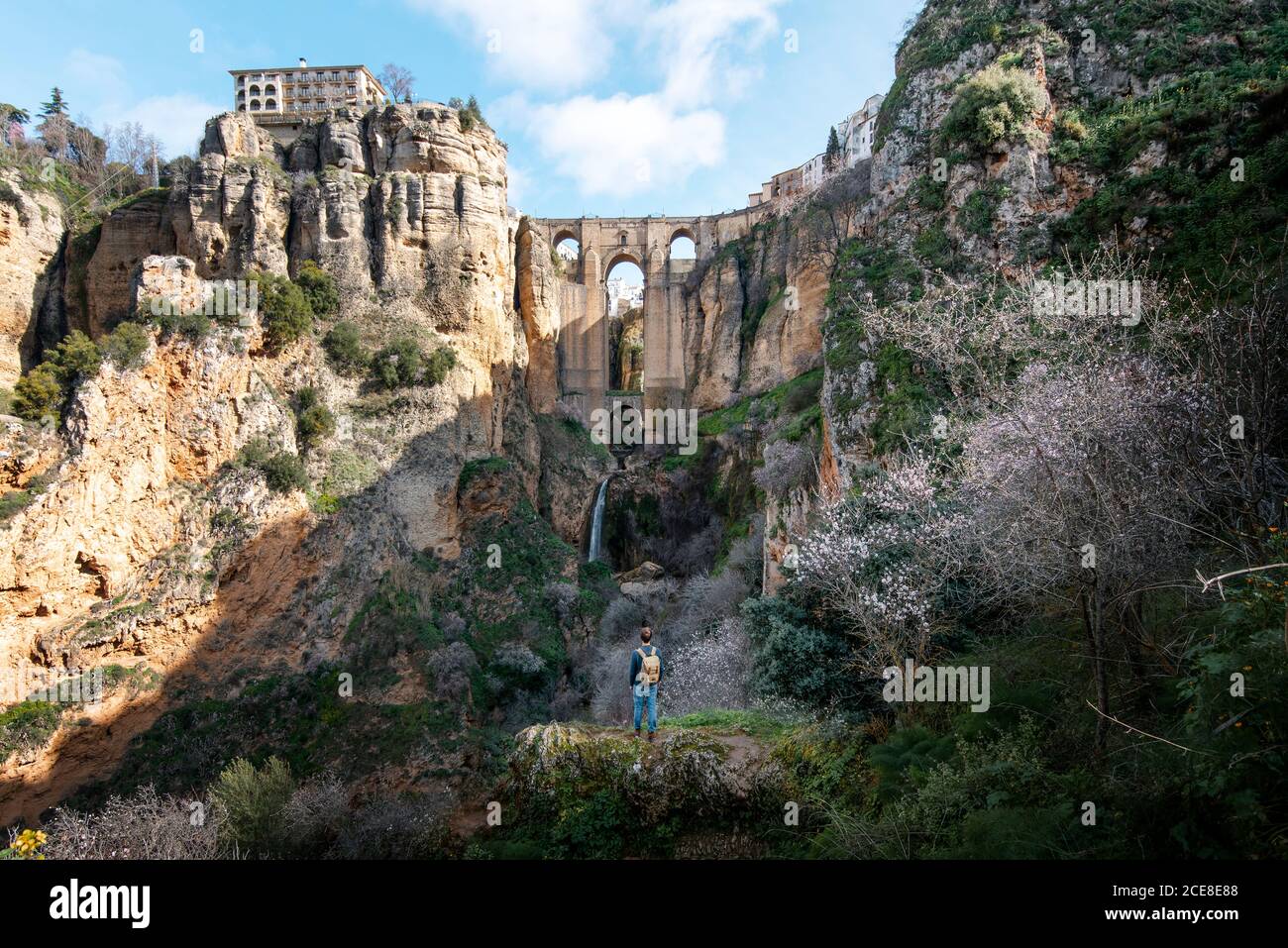 Back view full body faceless traveler standing at bottom of cliff and ...