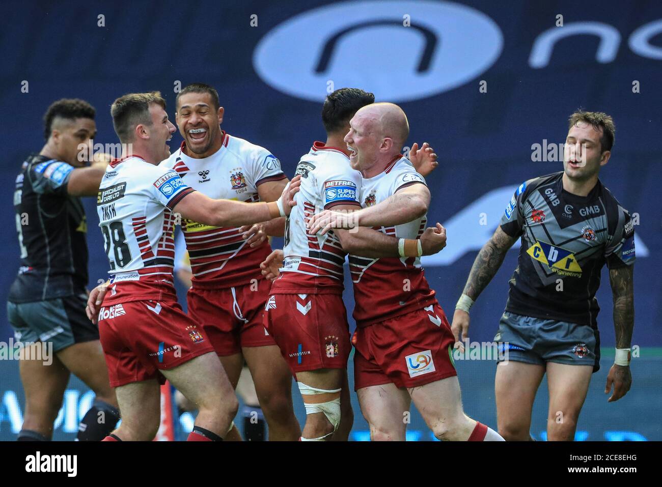 Liam Farrell (12) of Wigan Warriors celebrates his try with team mates ...