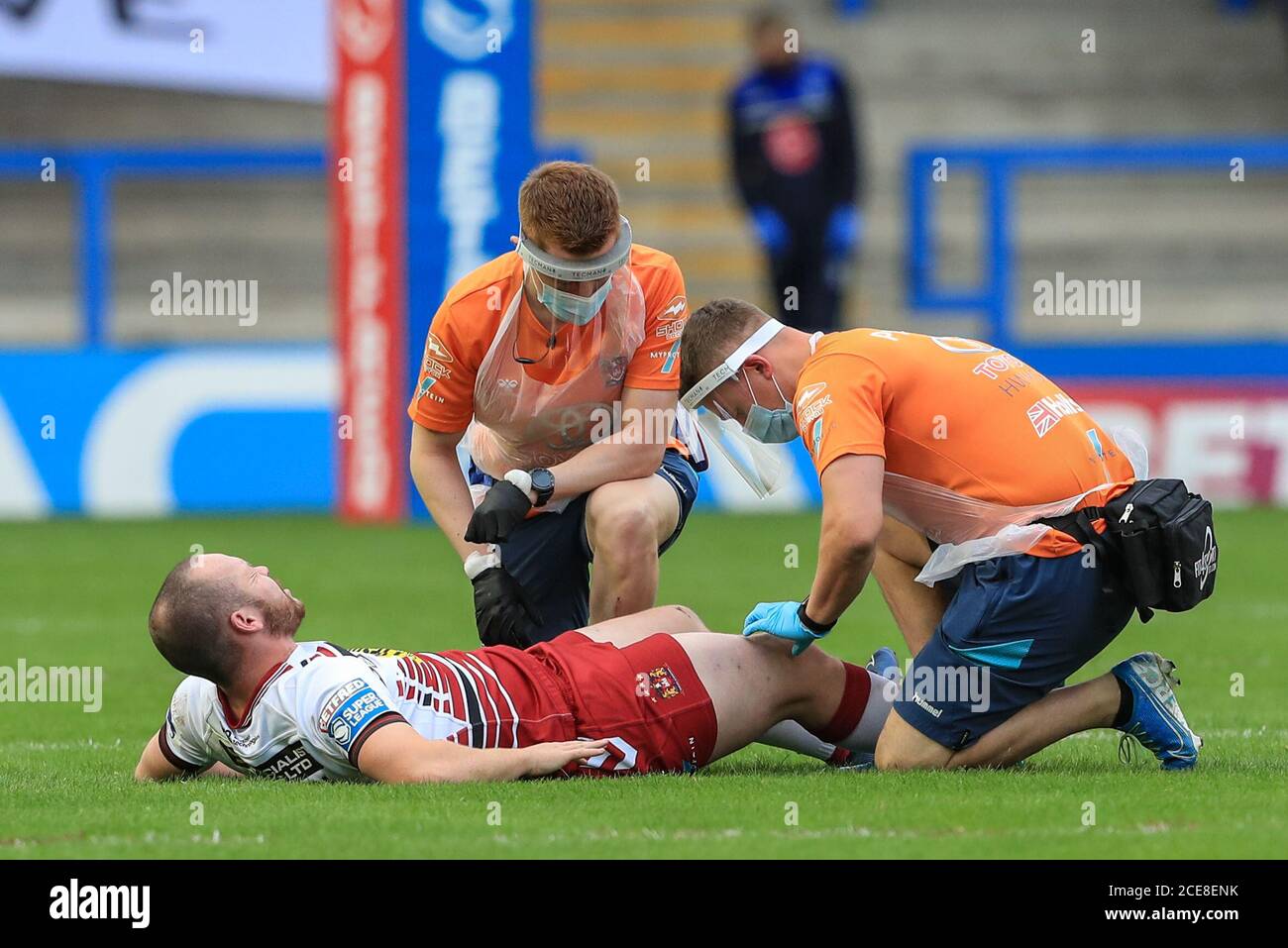 Liam Marshall (2) of Wigan Warriors receives treatment for a knee ...