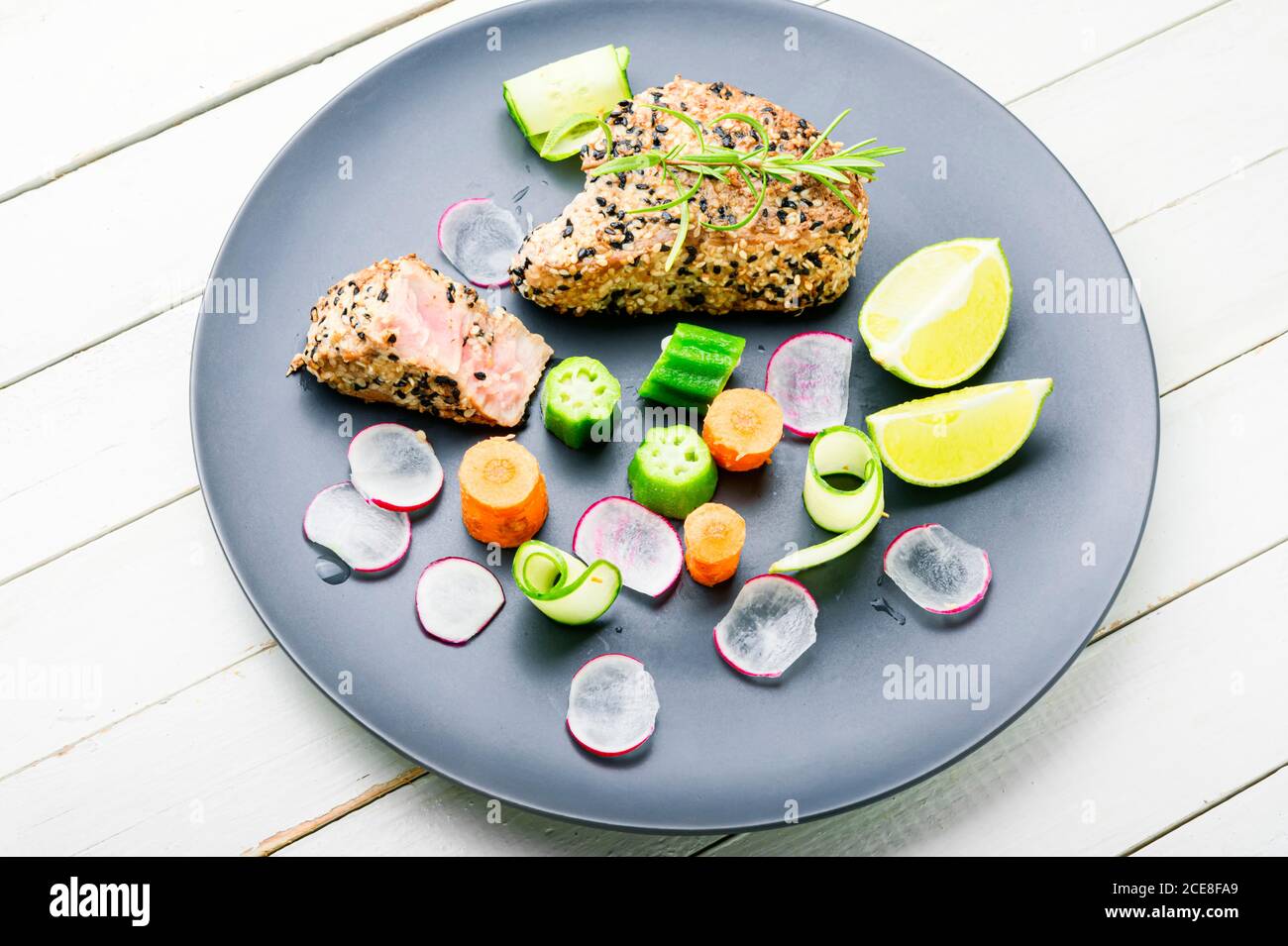 Baked tuna steak with vegetable garnish.Fish cooked with vegetables ...
