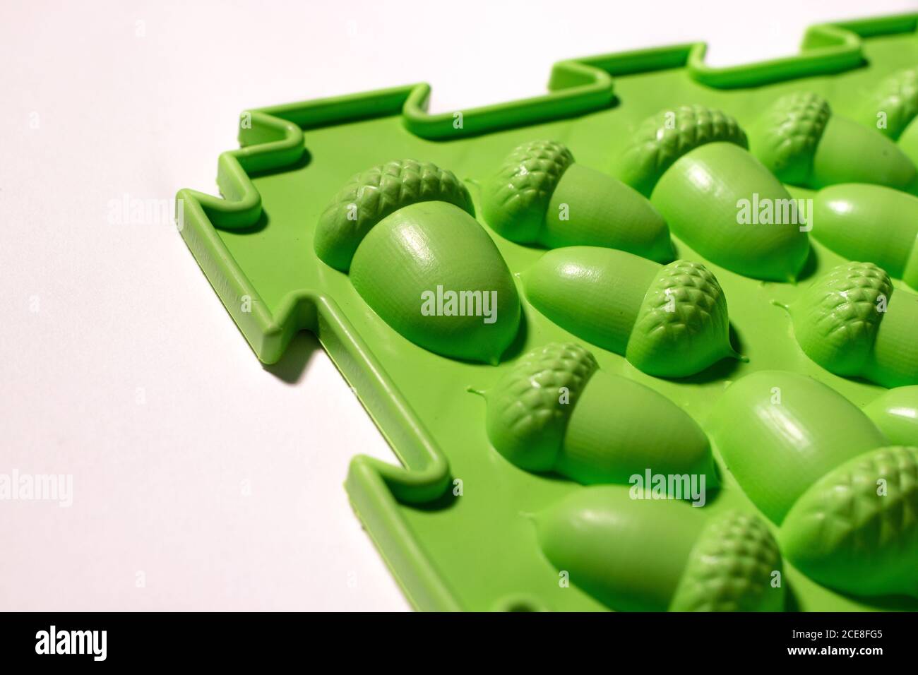 Green orthopedic mat in the form of acorns on a white background ...