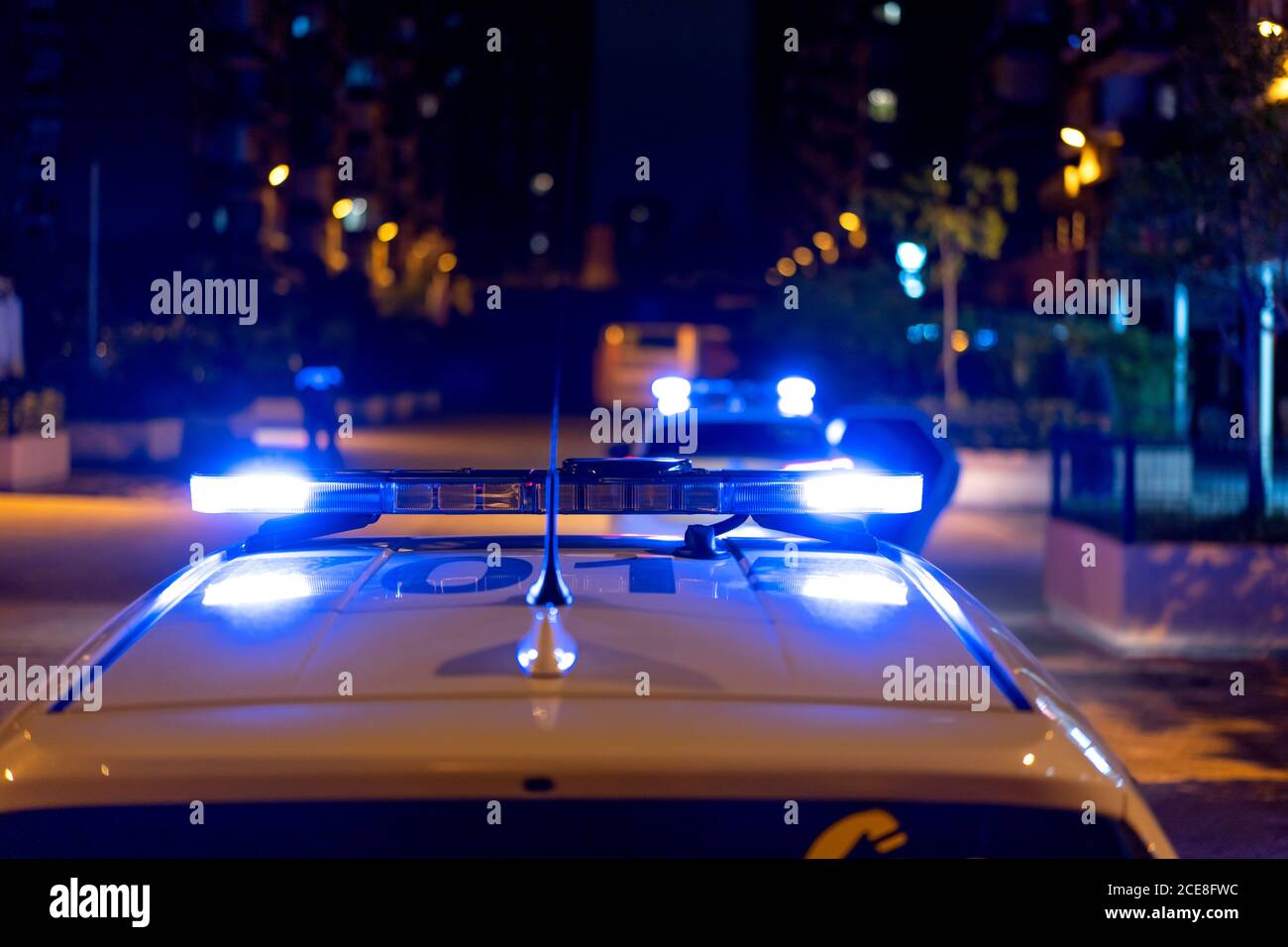Contemporary police vehicle with siren light on the road on background ...