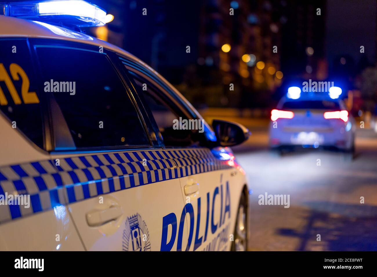 Contemporary police vehicle with siren light on the road on background ...