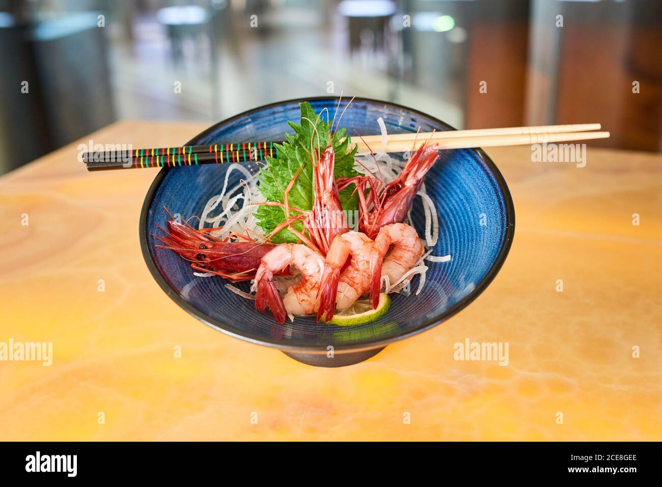 Traditional Sashimi with prawns served with daikon and slice of fresh ...