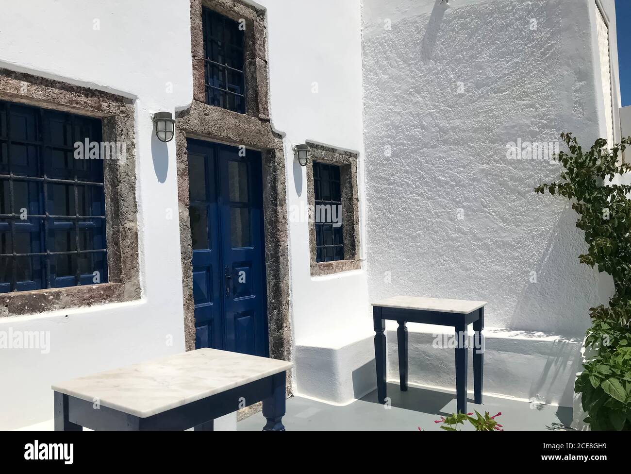 Beautiful white stone house exterior with blue windows Stock Photo - Alamy