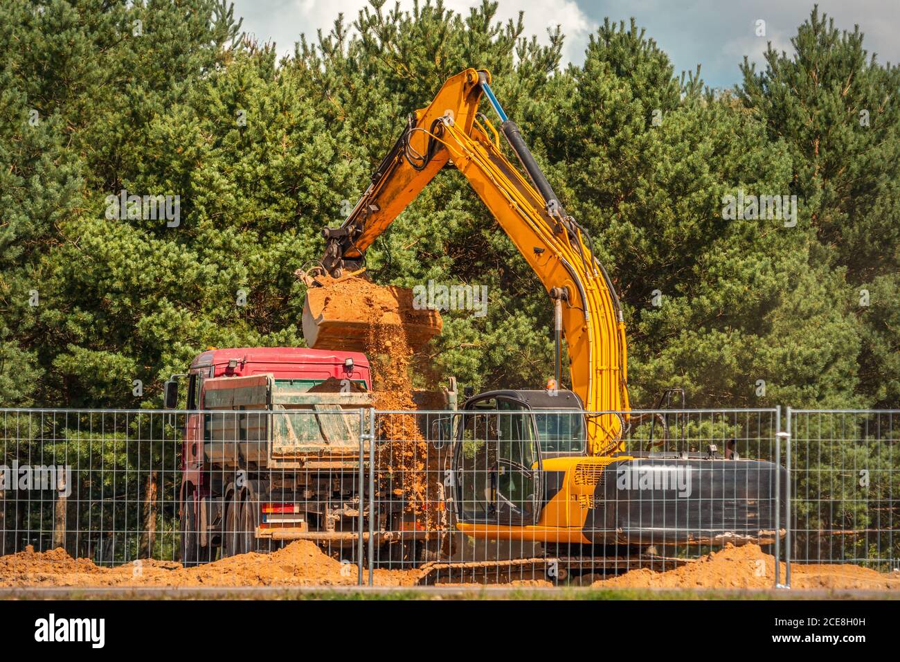 Excavator loading sand in rear-end tipper.Building Machines: Digger ...