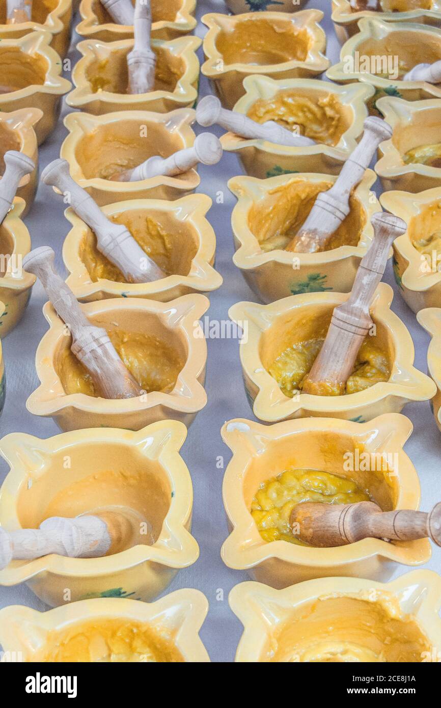 Alioli sauce being prepared in small yellow bowls Stock Photo - Alamy