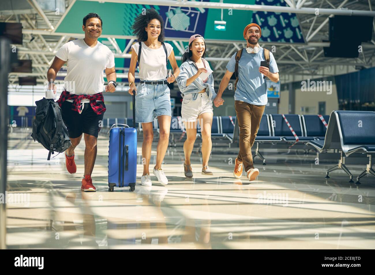 Woman airport baggage running hi-res stock photography and images - Alamy