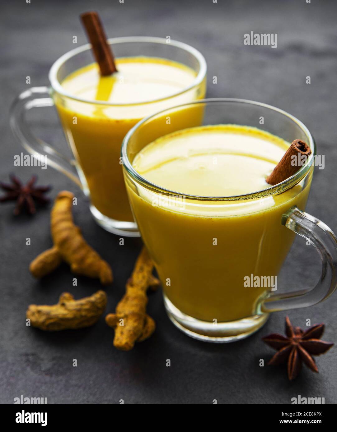 Yellow turmeric latte drink. Golden milk with cinnamon, turmeric ...
