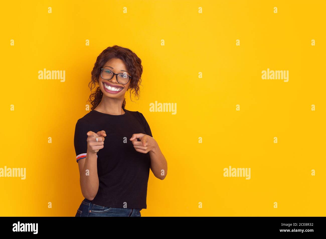 Pointing. Smiling girl with surreal huge smile and big mouth looks ...