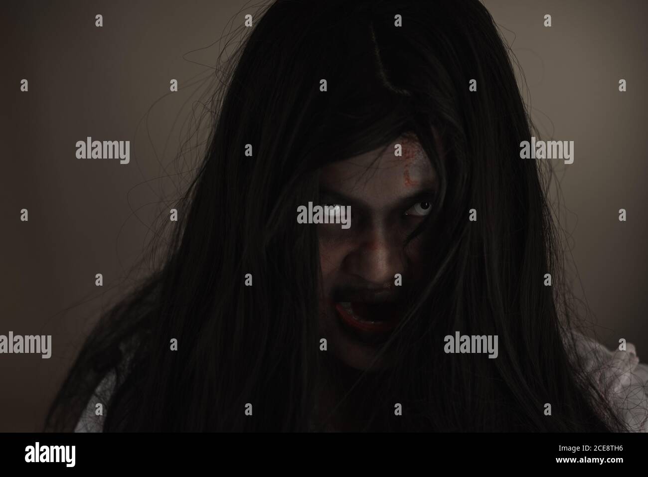 Girl zombie in blood. Closeup face and eyes of Asian Woman ghost with ...