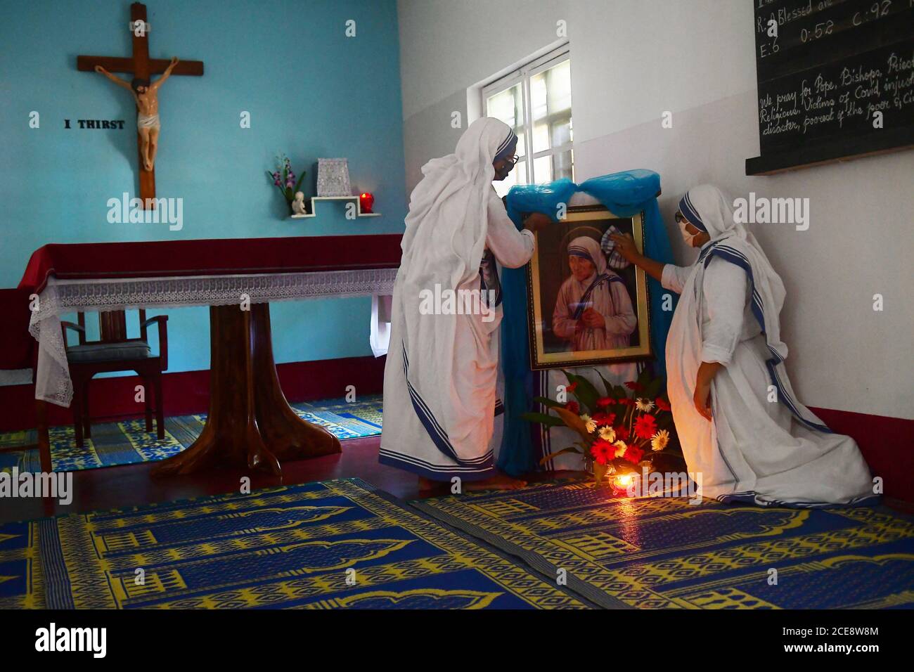 Catholic nuns from Nirmala Shishu Bhavan cleaning the photograph of ...