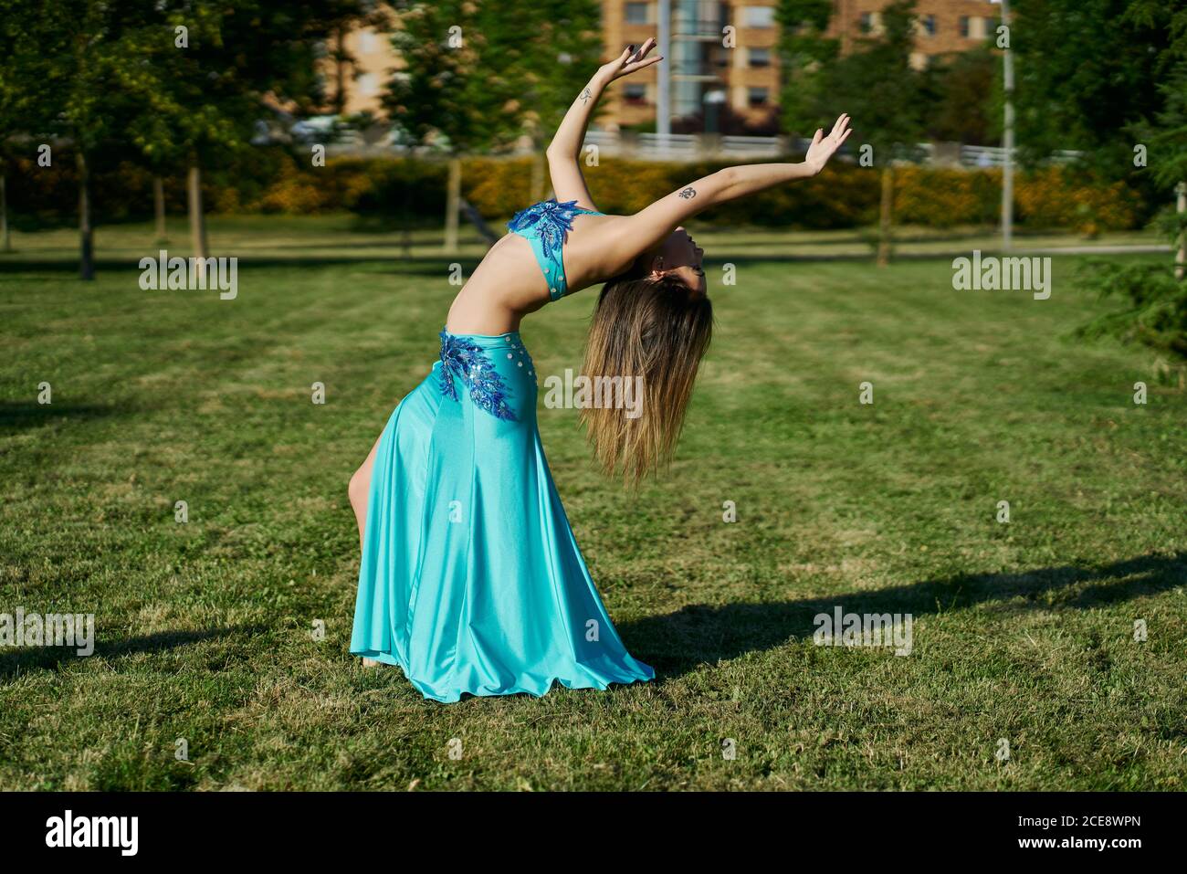 Side view of flexible Woman in creative costume performing dancing ...
