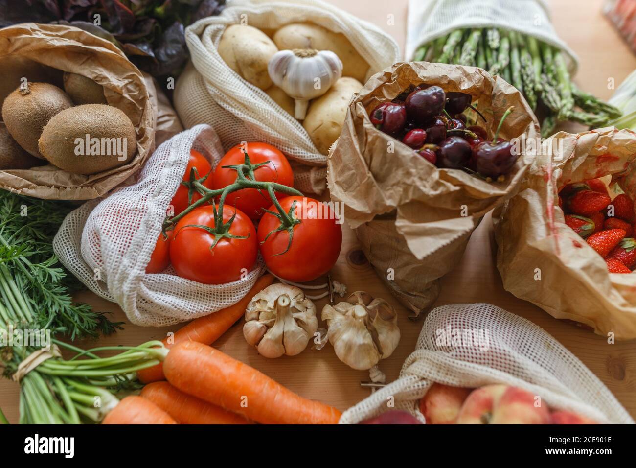 Assorted vegetables and fruits in paper and mesh cotton fabric reusable ...