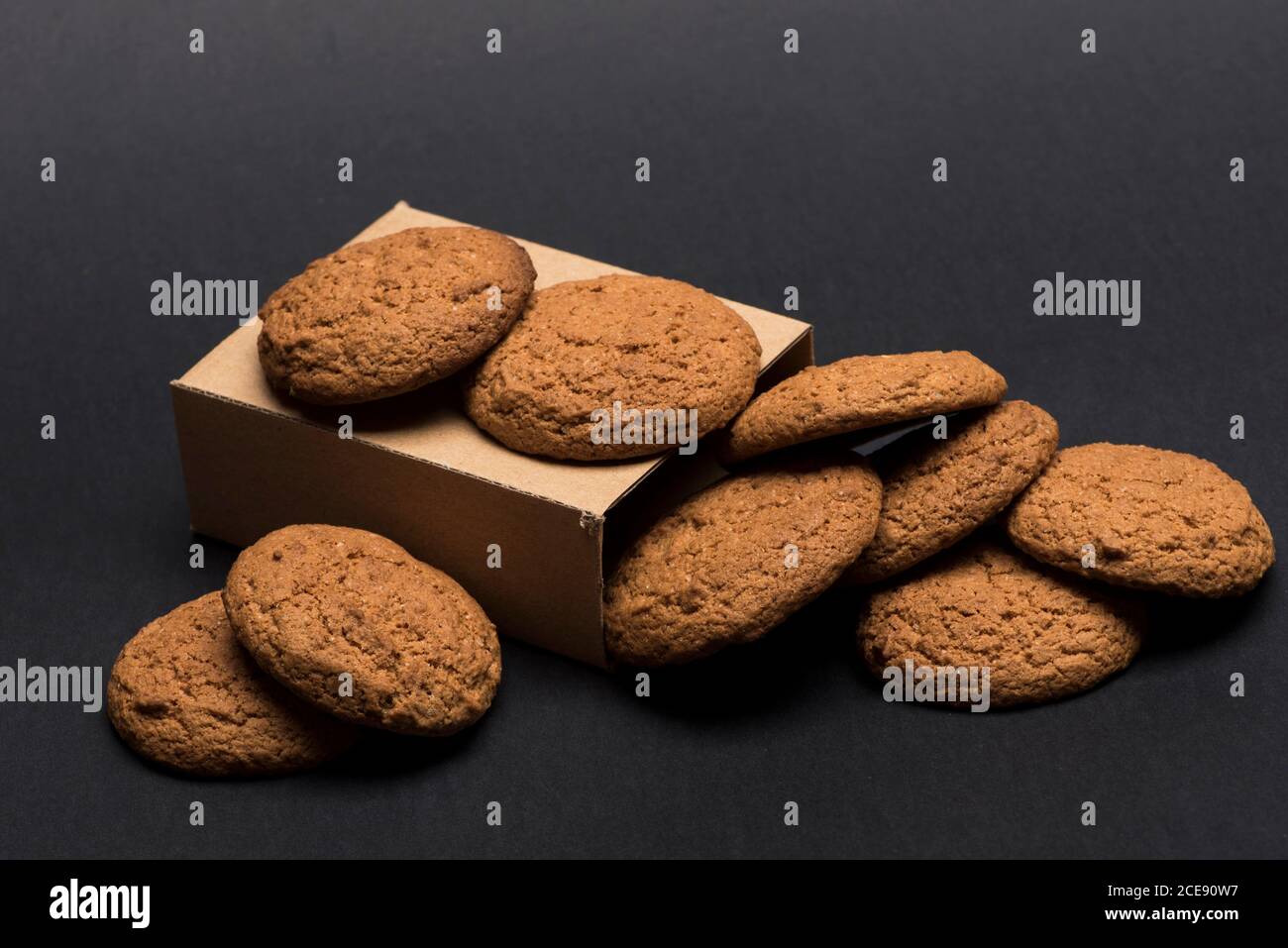 Cookies in carton box on dark grey background. Nutrition and bakery ...