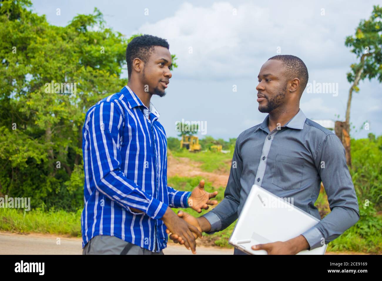 African men discussing business plans standing in a farmland Stock ...