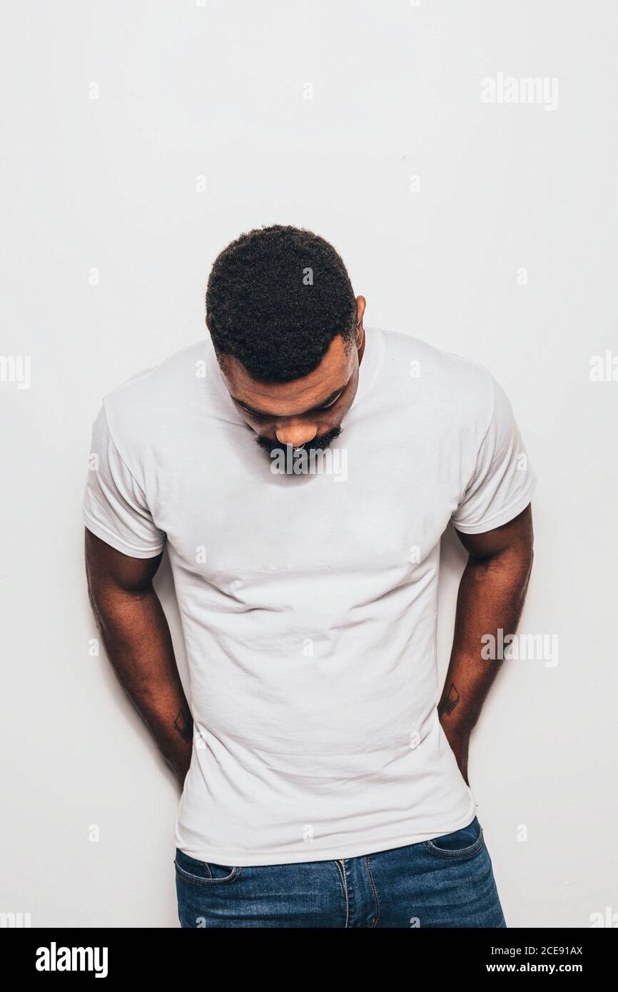 Serious black man with casual outfit posing over white background ...