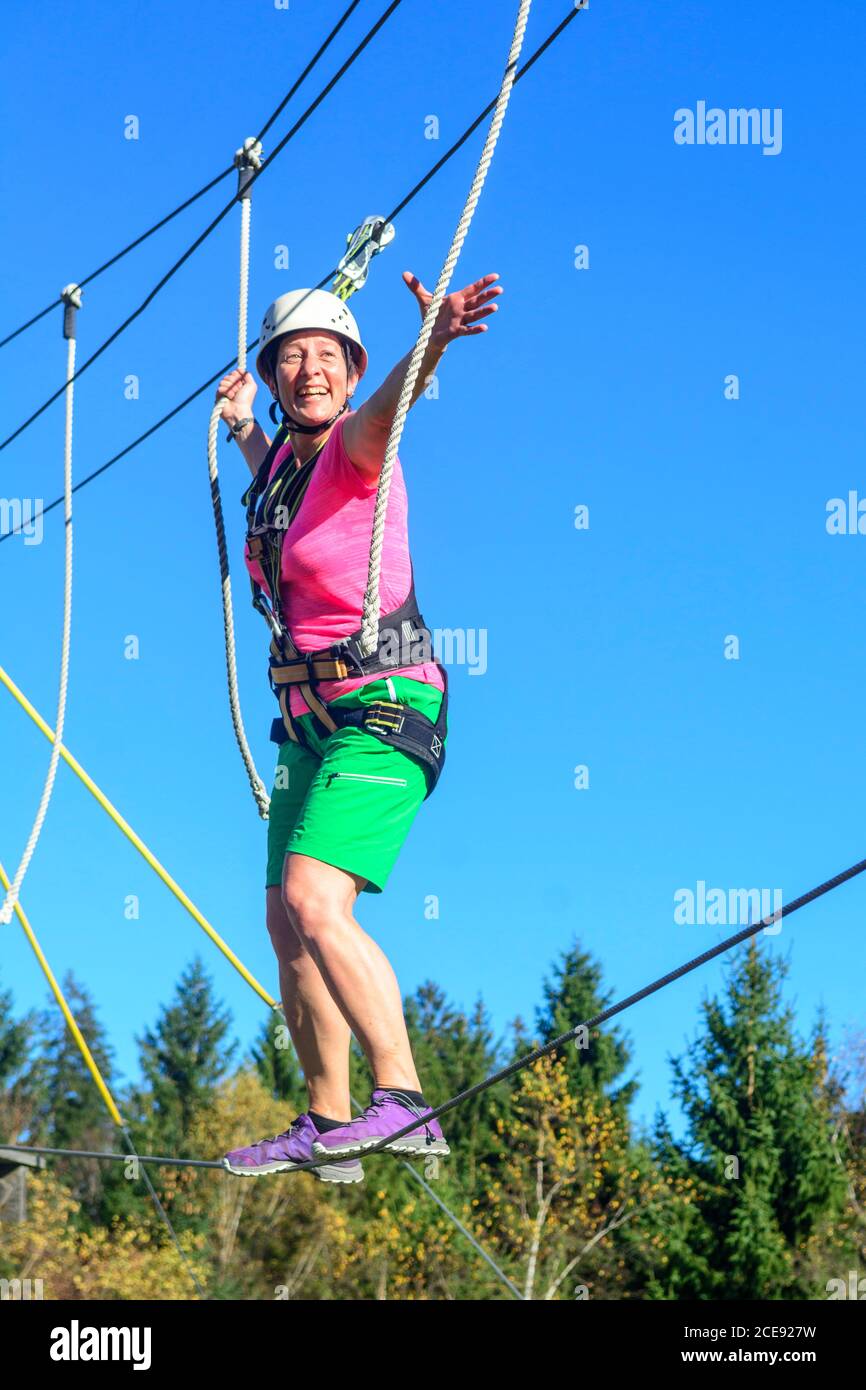 Balancing exercise in high ropes course Stock Photo - Alamy