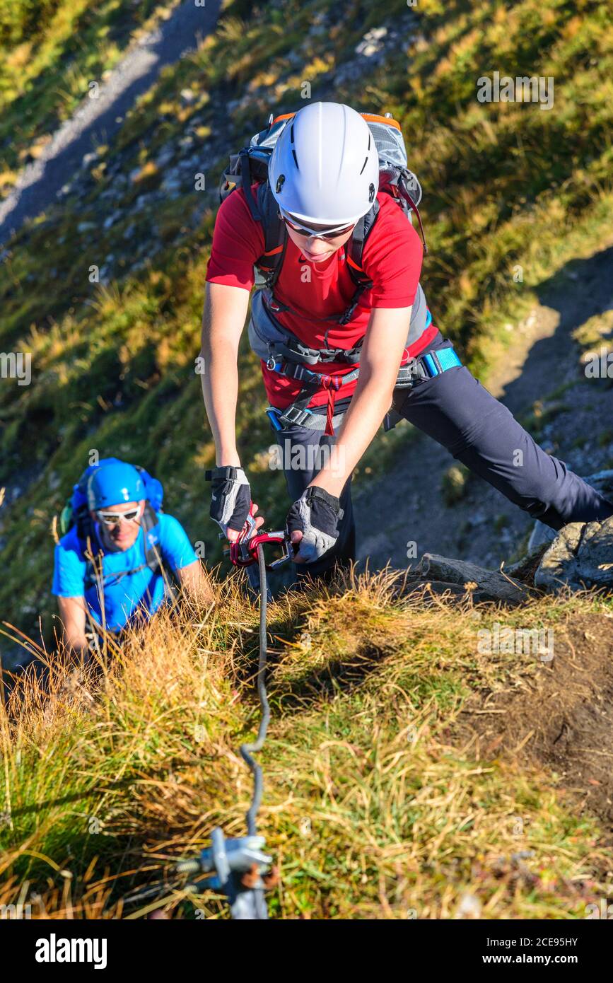 Climbing in via ferrata style in high alpine region in western Austria ...