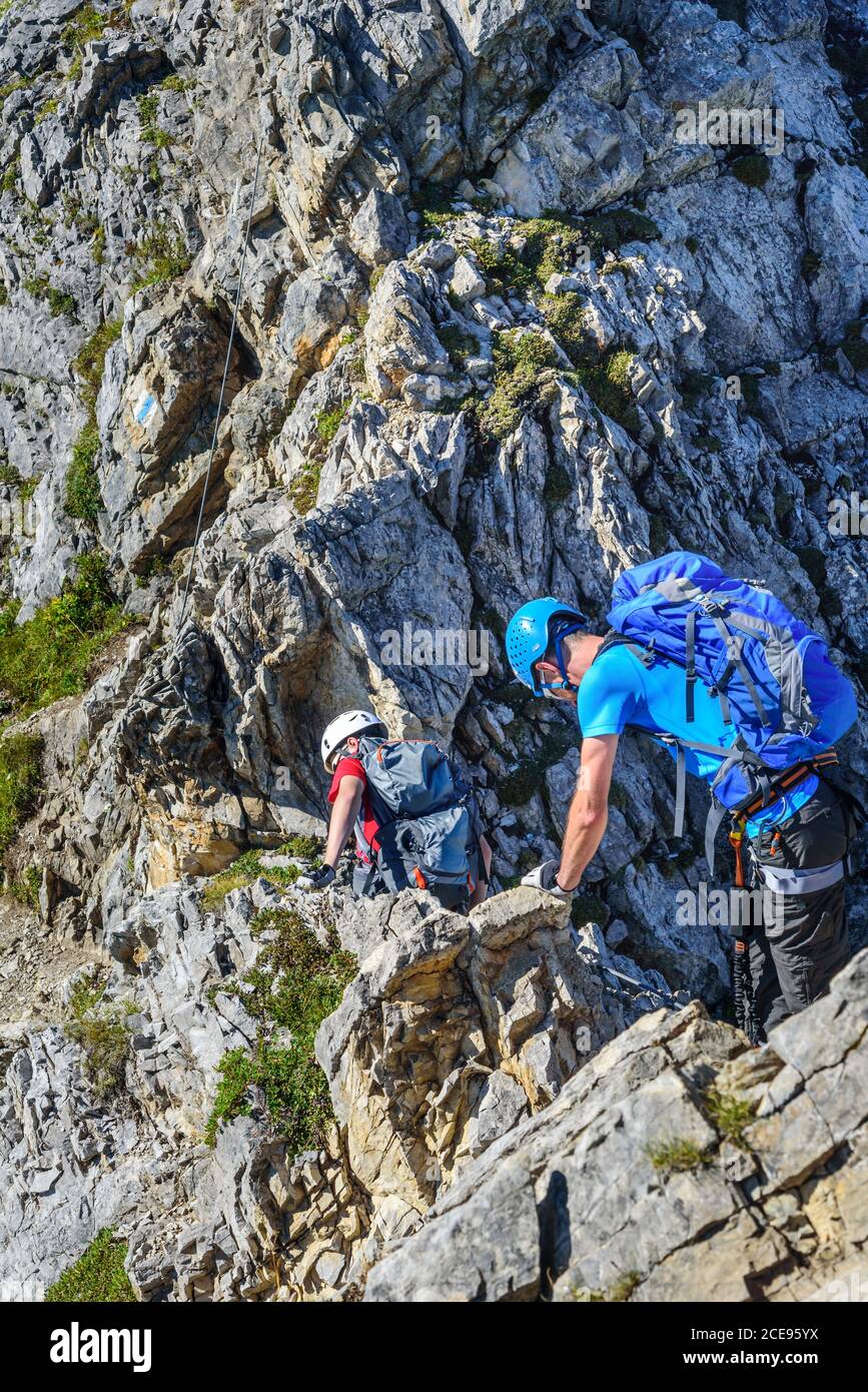 Climbing in via ferrata style in high alpine region in western Austria ...