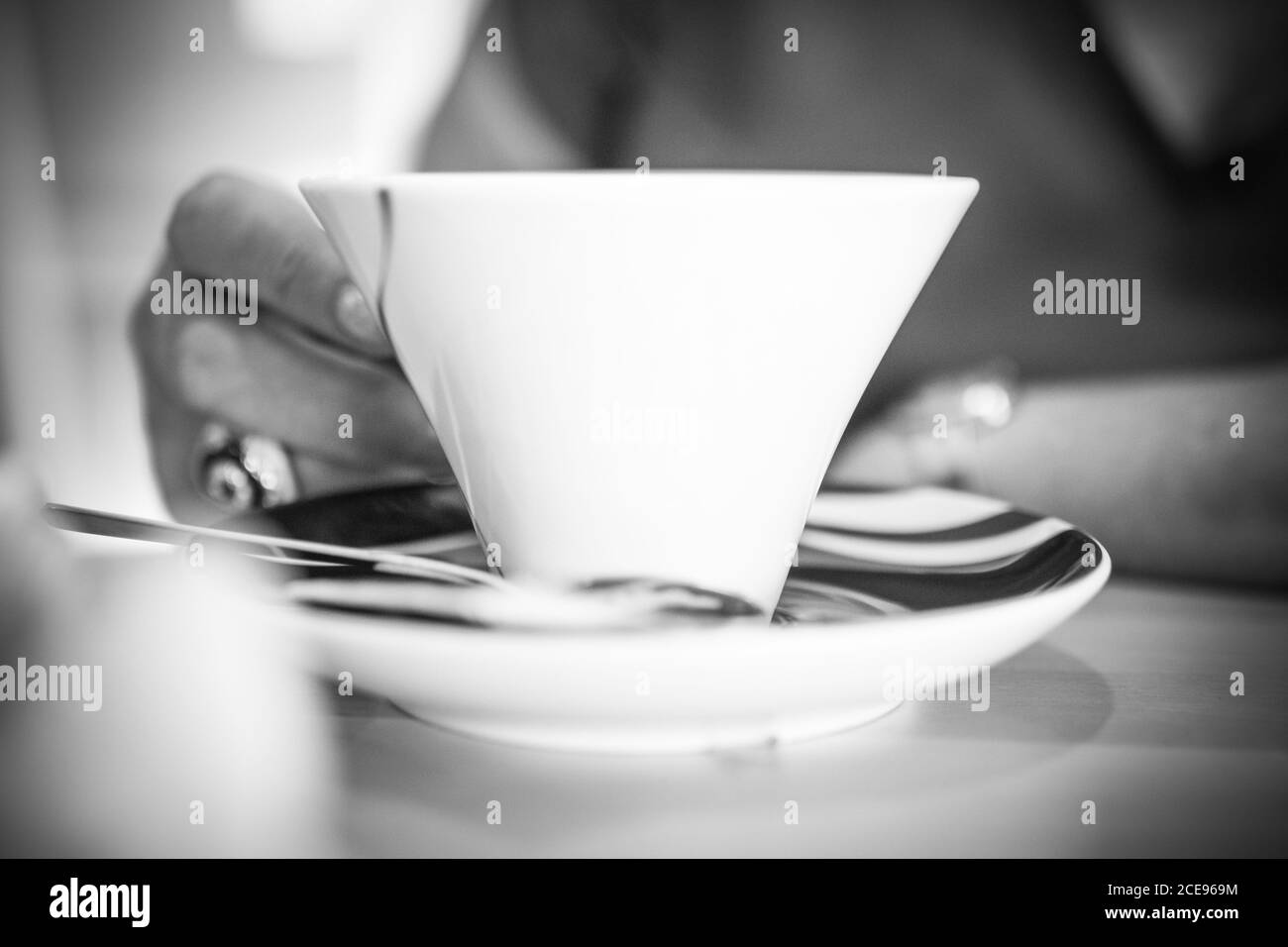 Hand holding coffee black background Black and White Stock Photos ...