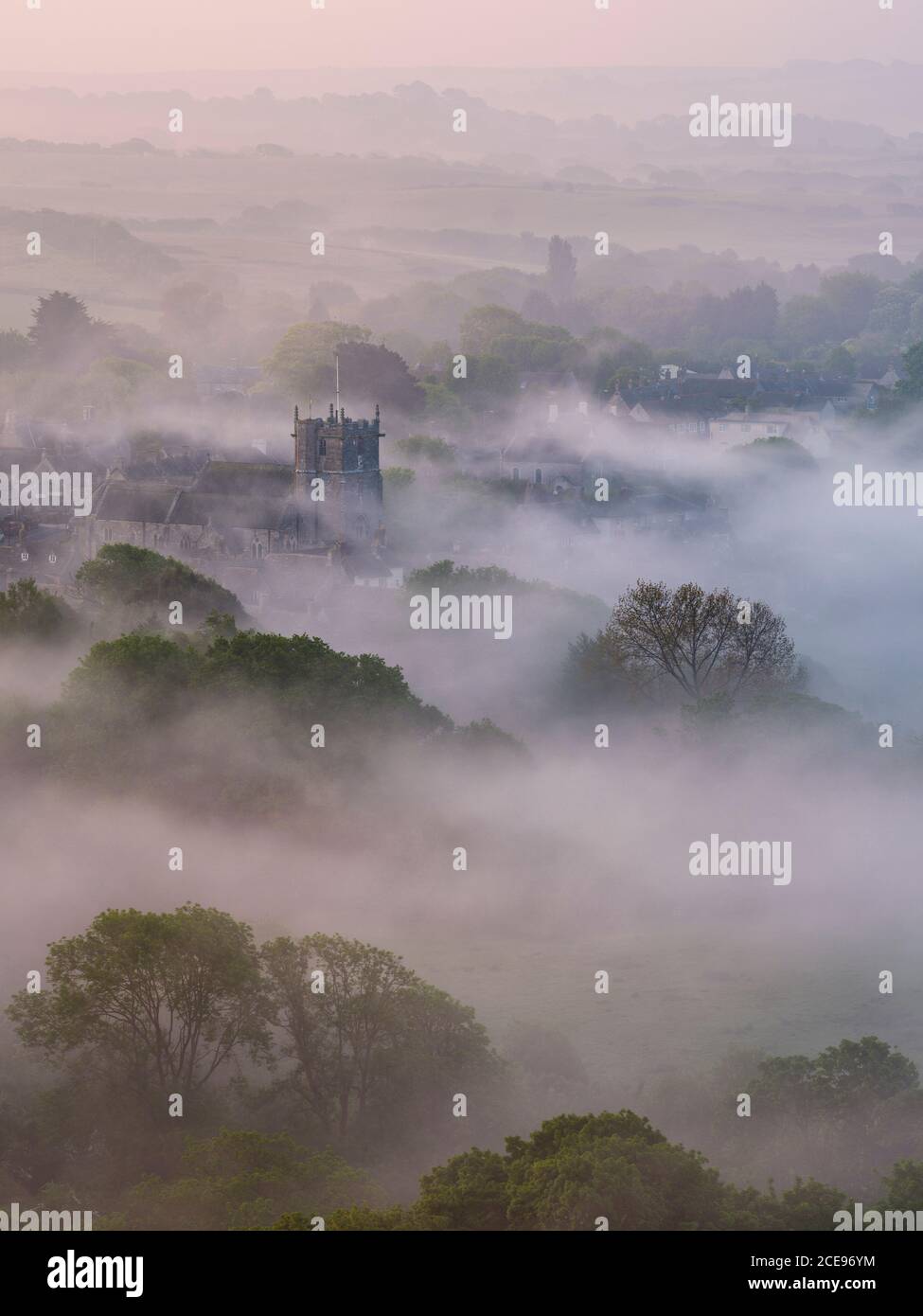 Elevated shot of a church tower in the mist Stock Photo - Alamy