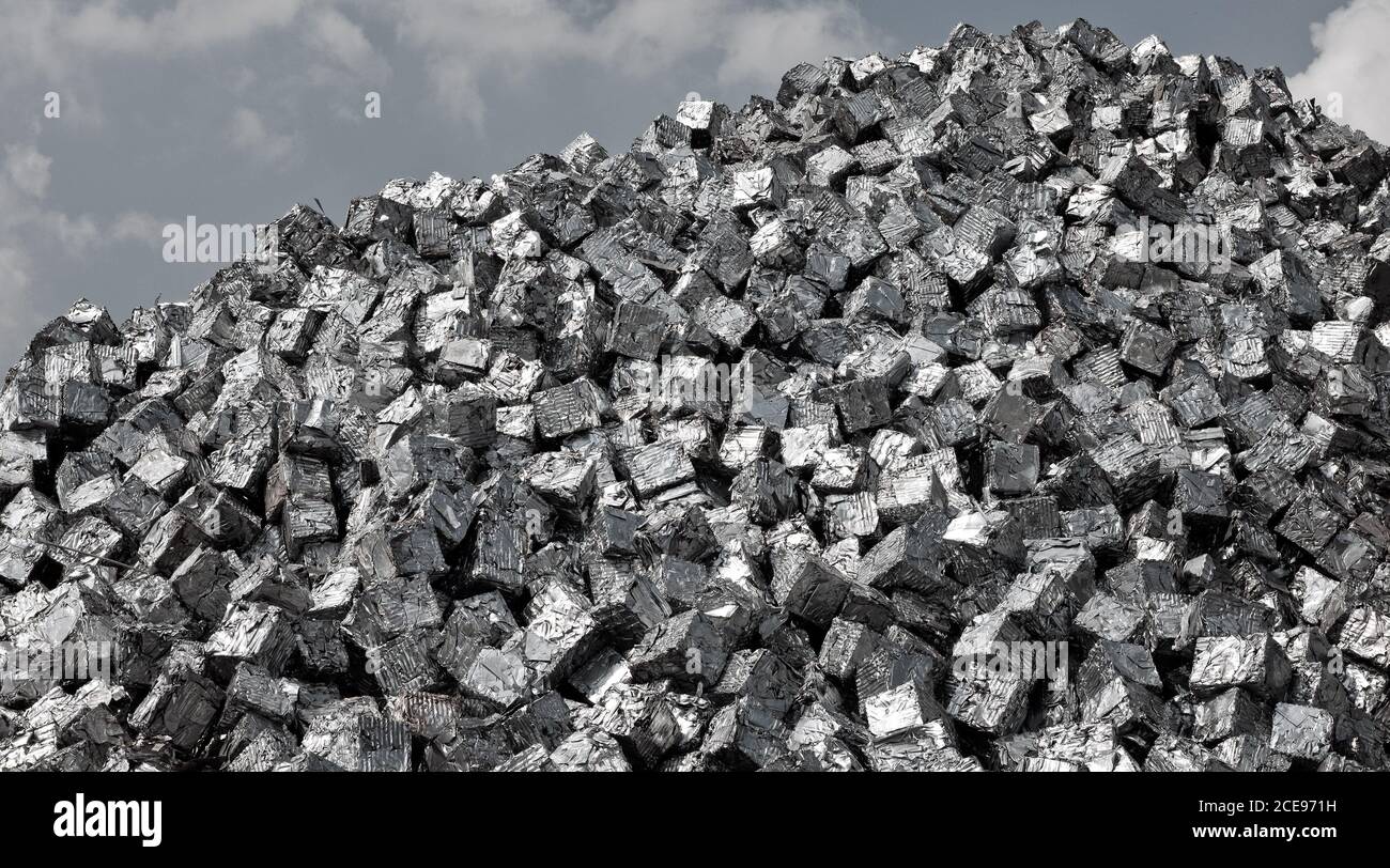 A large pile of silver gray square metal cubes on the premises of a ...