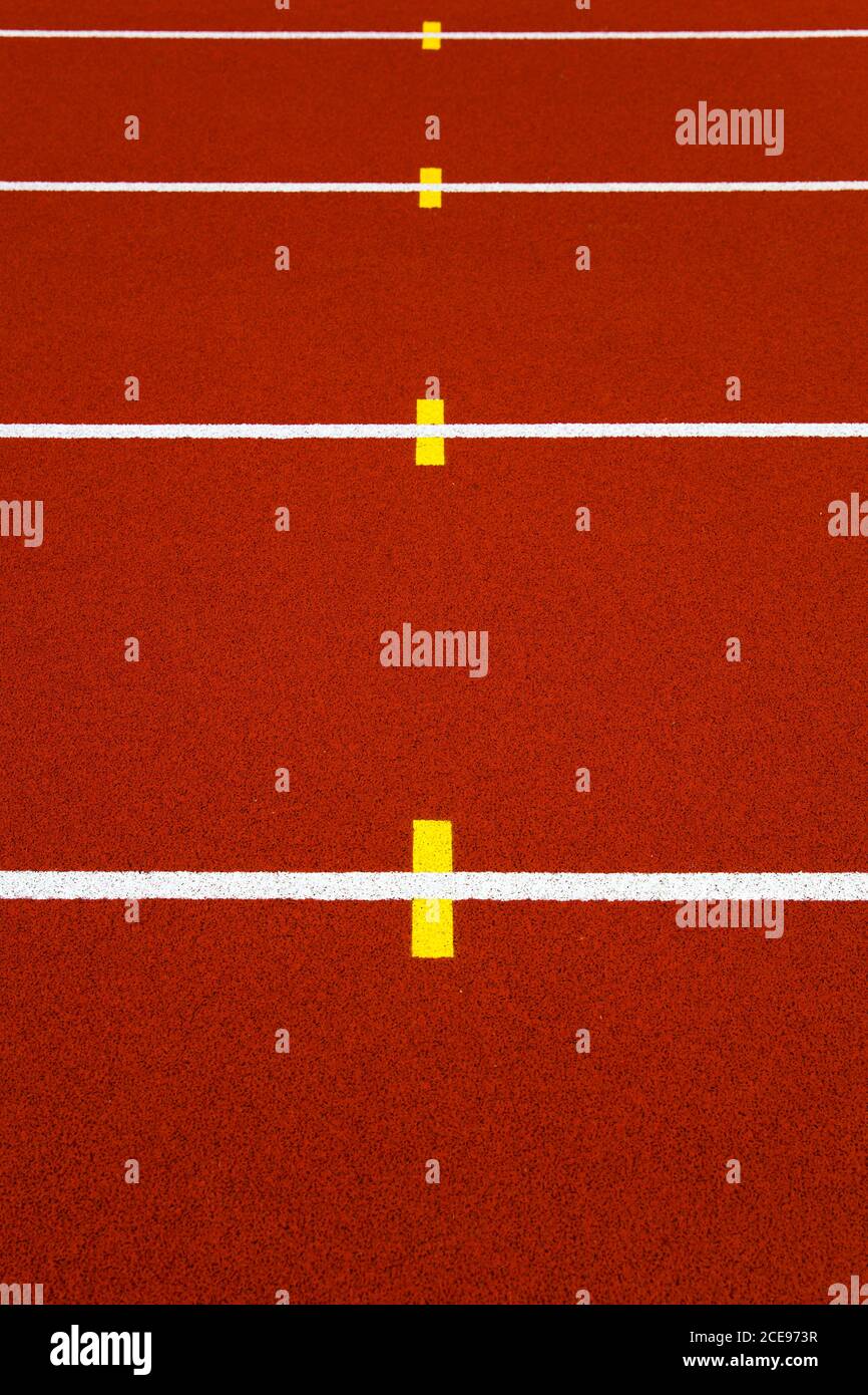 Closeup of the white lines on red stadium running track Stock Photo - Alamy