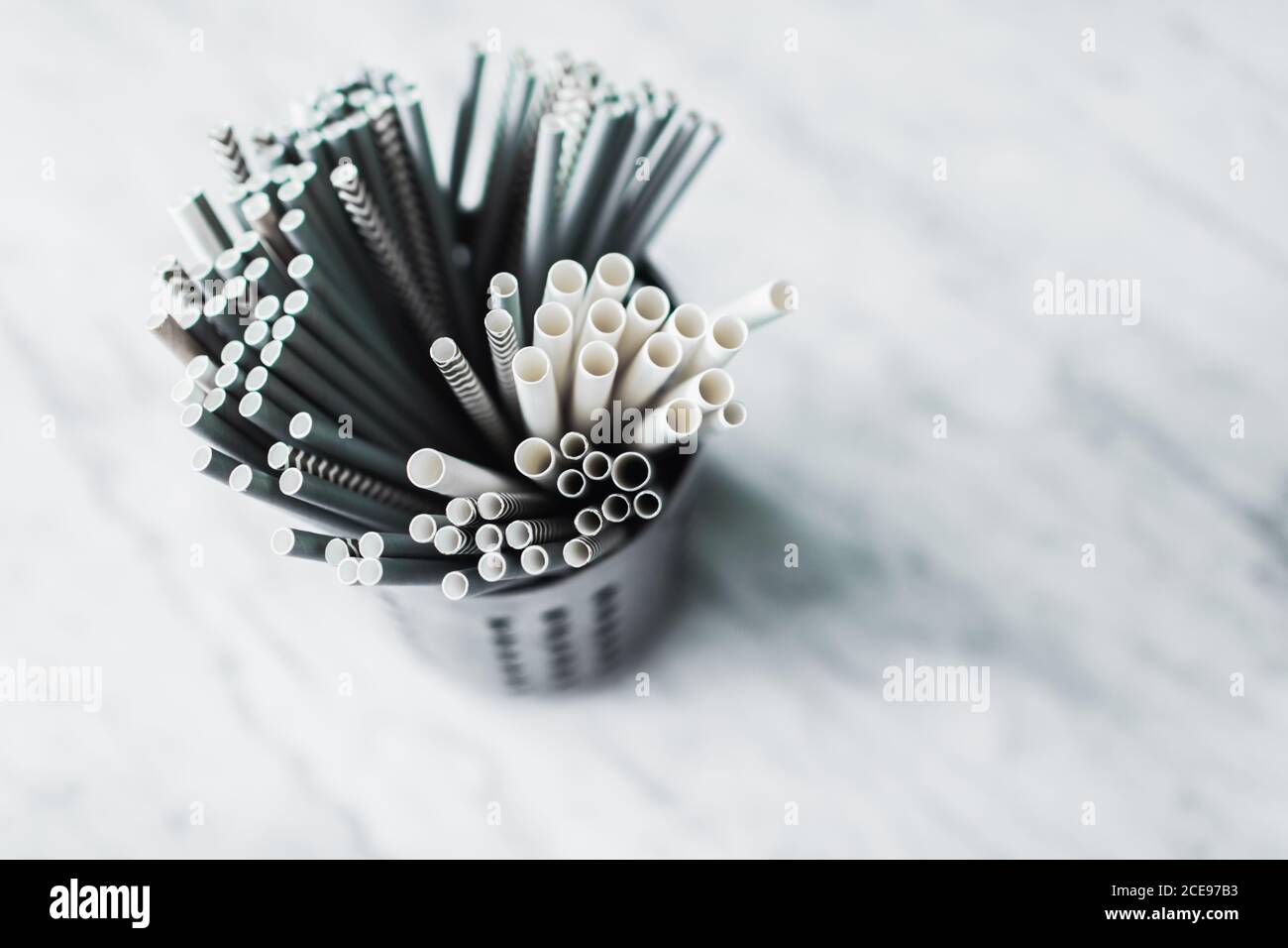 Set of different paper drinking straws on gray concrete background in ...
