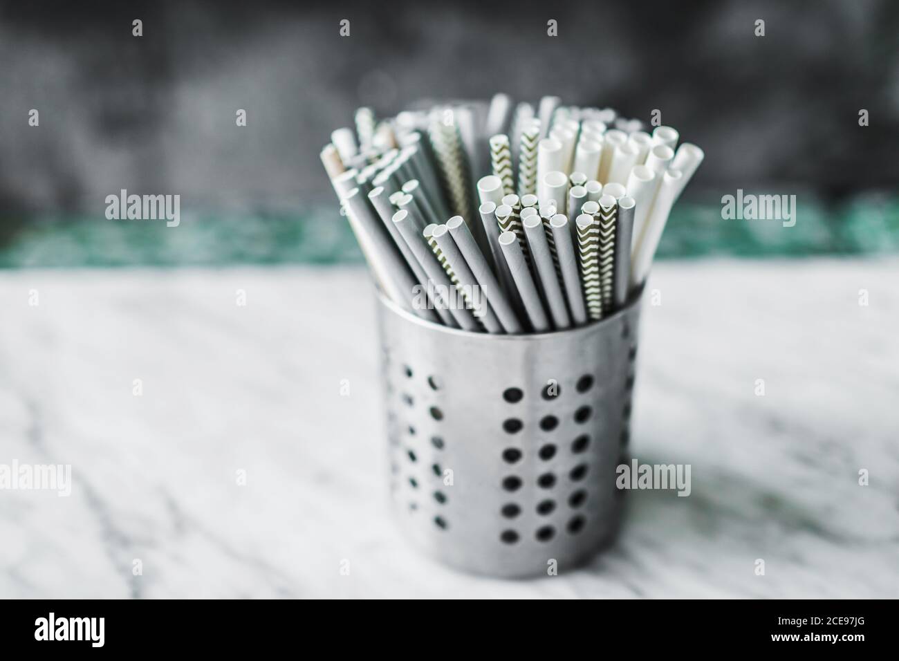 Set of different paper drinking straws on gray concrete background in ...