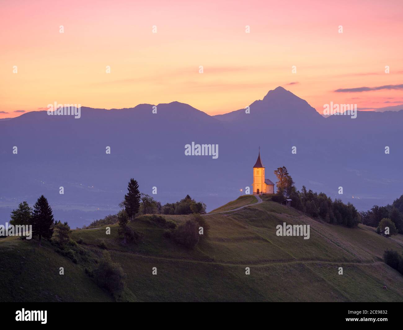 Sunrise over a church at Jamnik in the Julian Alps Stock Photo - Alamy