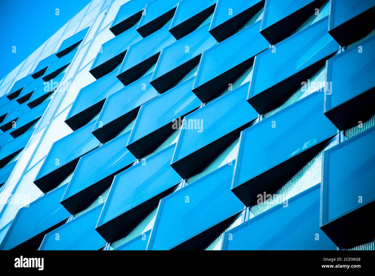 Angular abstract glass rectangles on the side of an office building ...