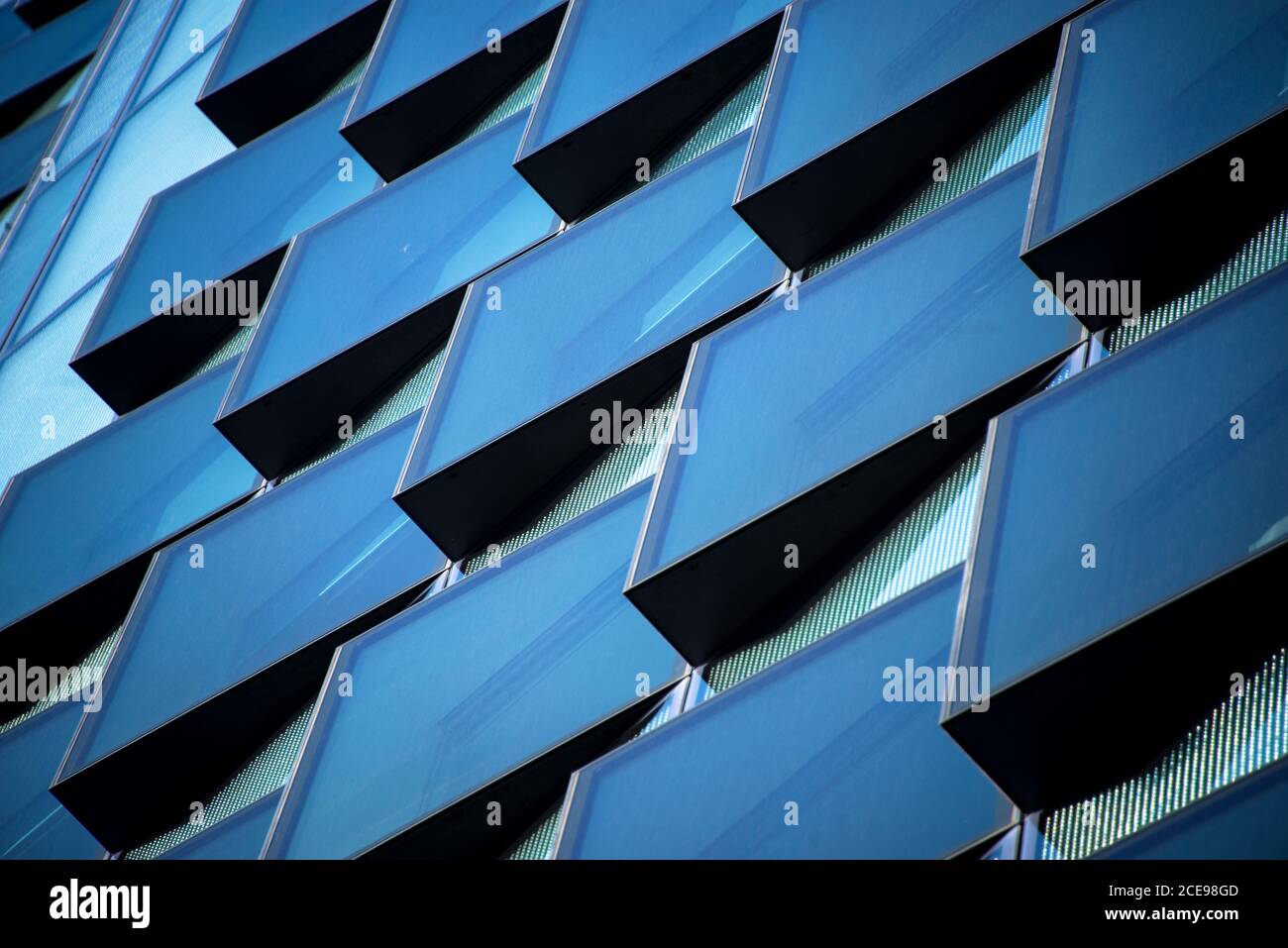 Angular abstract glass rectangles on the side of an office building ...