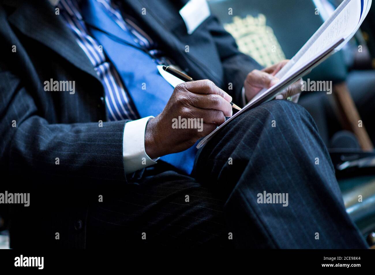 Close up of a man in a suit making notes at a conference seminar Stock ...
