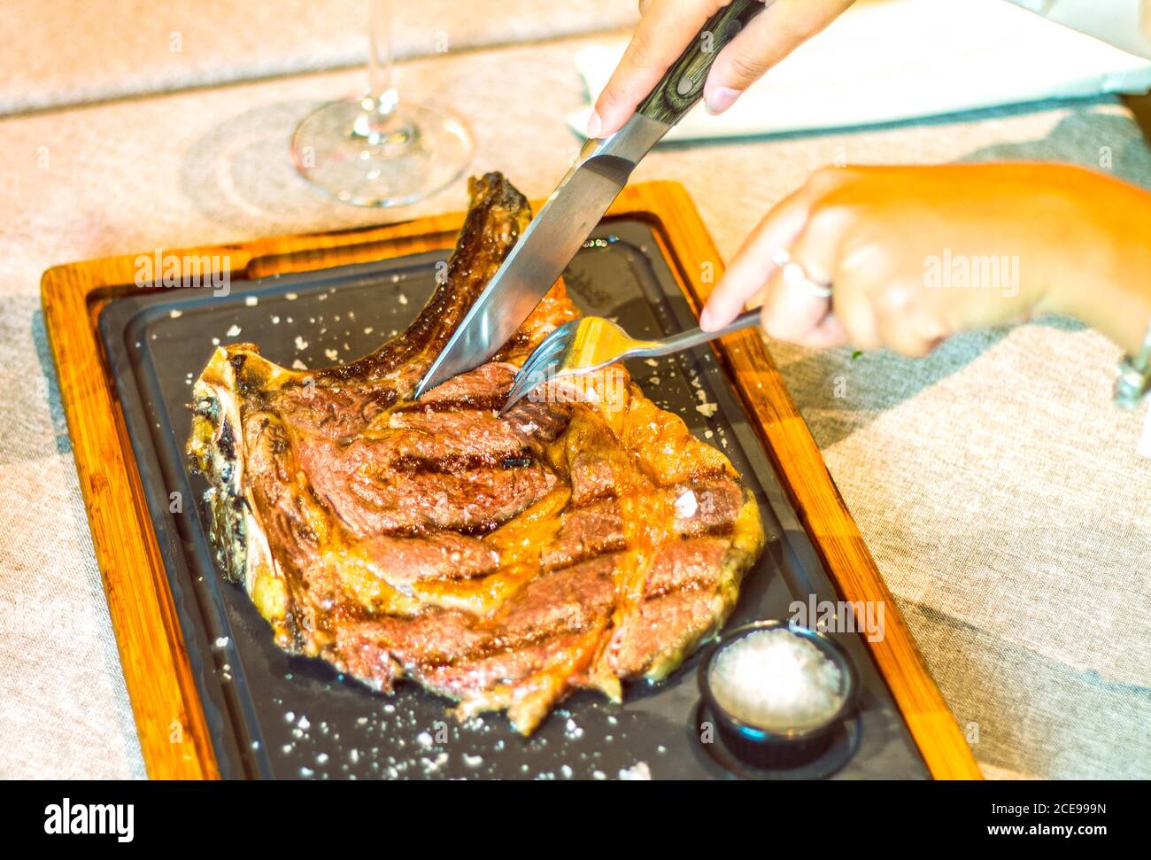 Woman cutting grilled steak hi-res stock photography and images - Alamy
