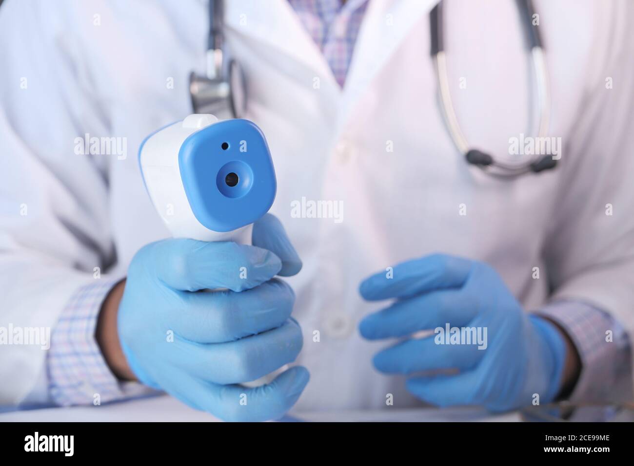 Hand holding infrared thermometer to measuring temperature Stock Photo ...