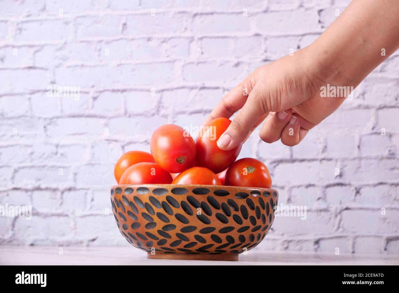 Hand person picking tomatoes from hi-res stock photography and images ...