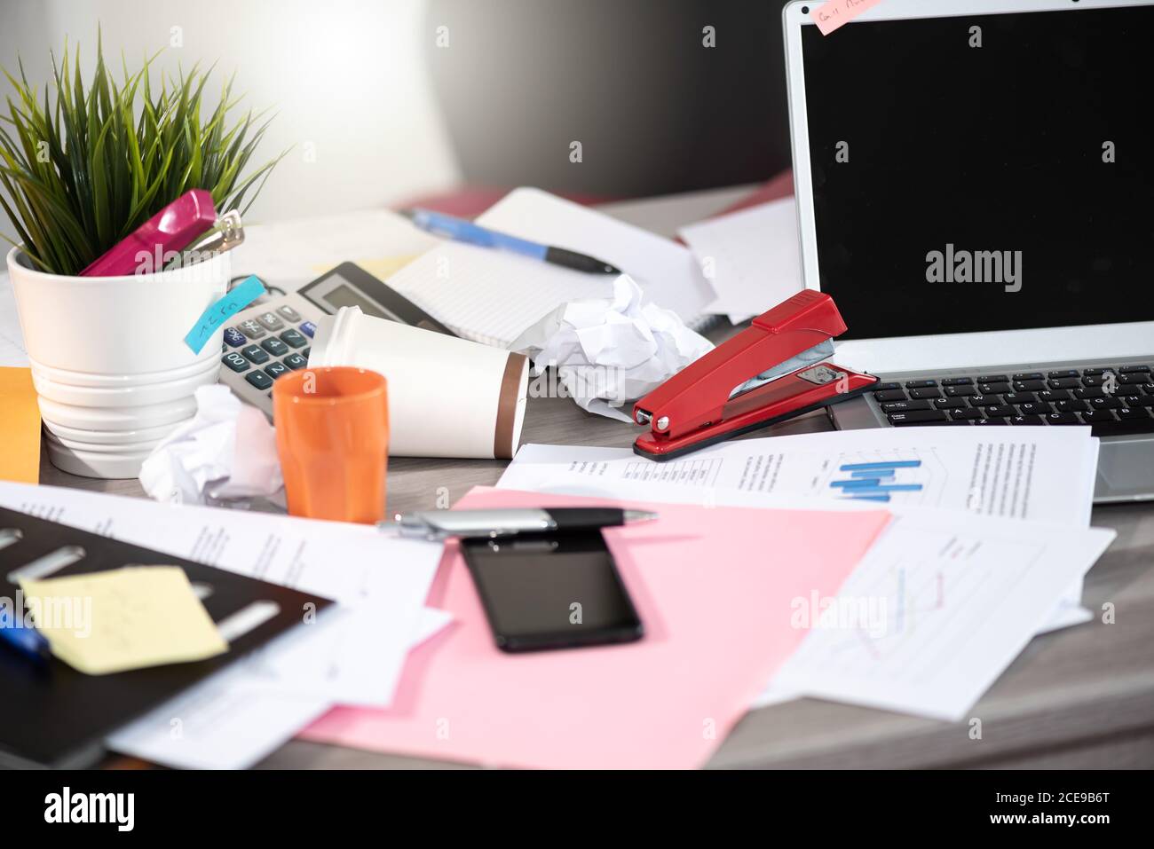 Messy and cluttered office desk Stock Photo - Alamy