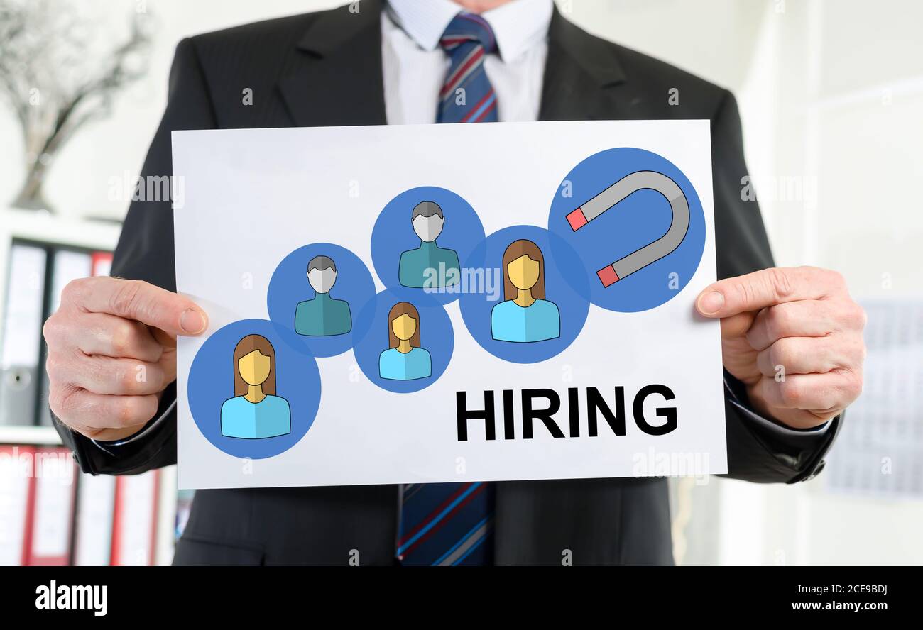 Paper showing hiring concept held by a businessman Stock Photo - Alamy