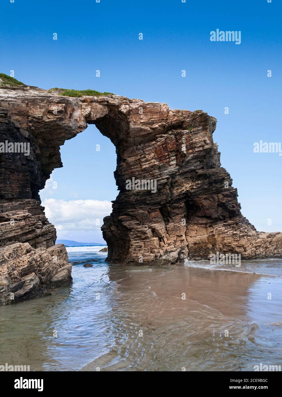 Arch-shaped rock formation on Las Catedrales beach in Galicia in Spain ...