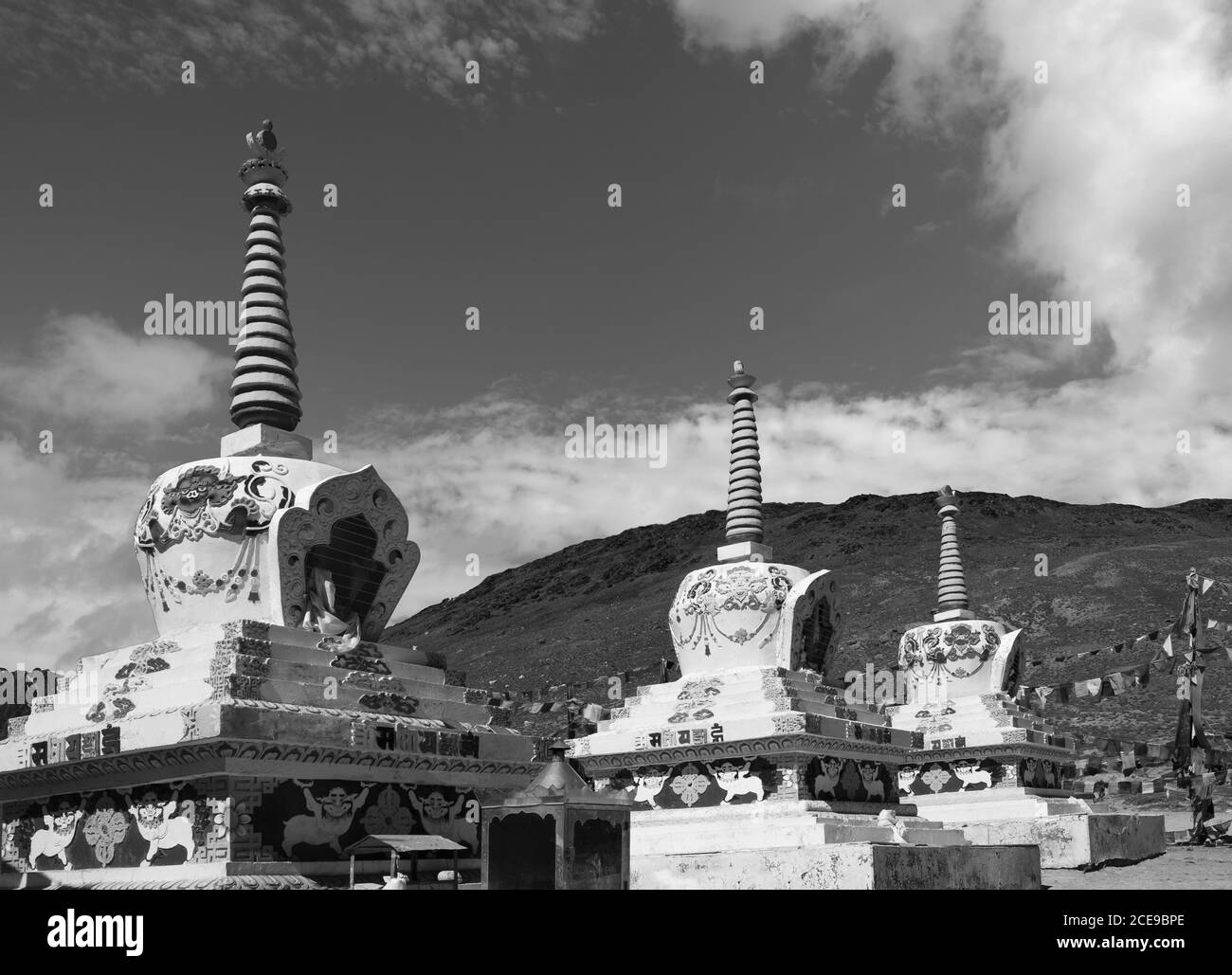 Buddhist stupas with prayer flags overlooking snow-peaked Himalayas ...