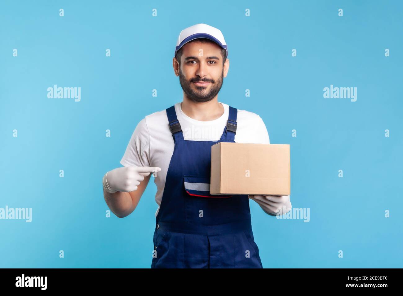 Cargo transportation, delivery service. Friendly worker in uniform ...