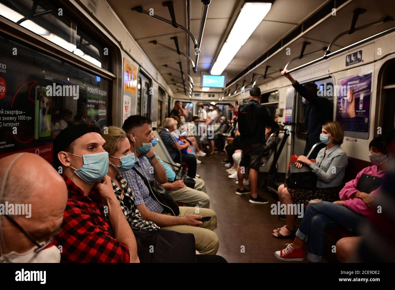 Passengers in subway trains ride in protective masks in accordance with ...