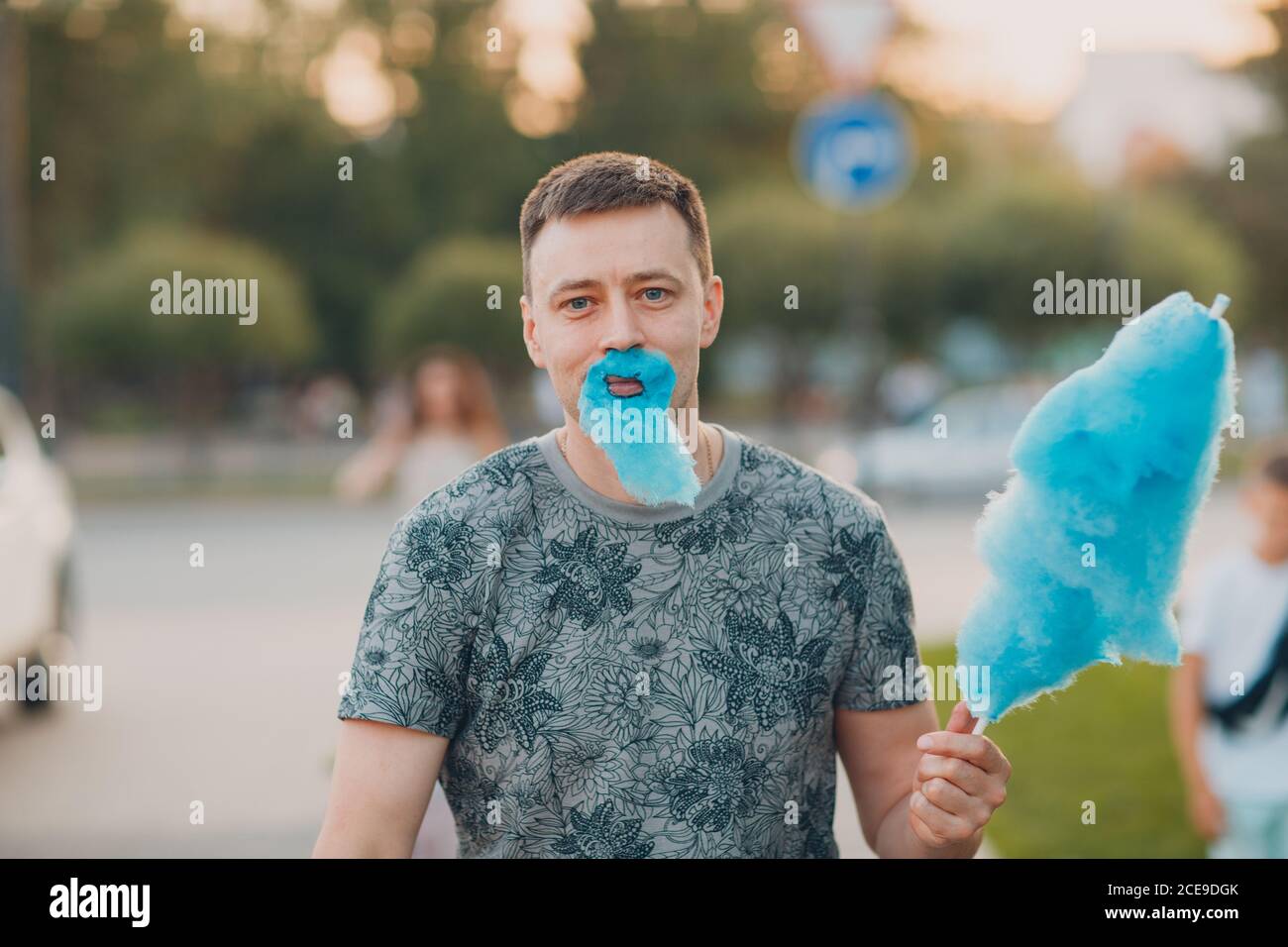 Young adult man with beard made of blue cotton candy Stock Photo - Alamy
