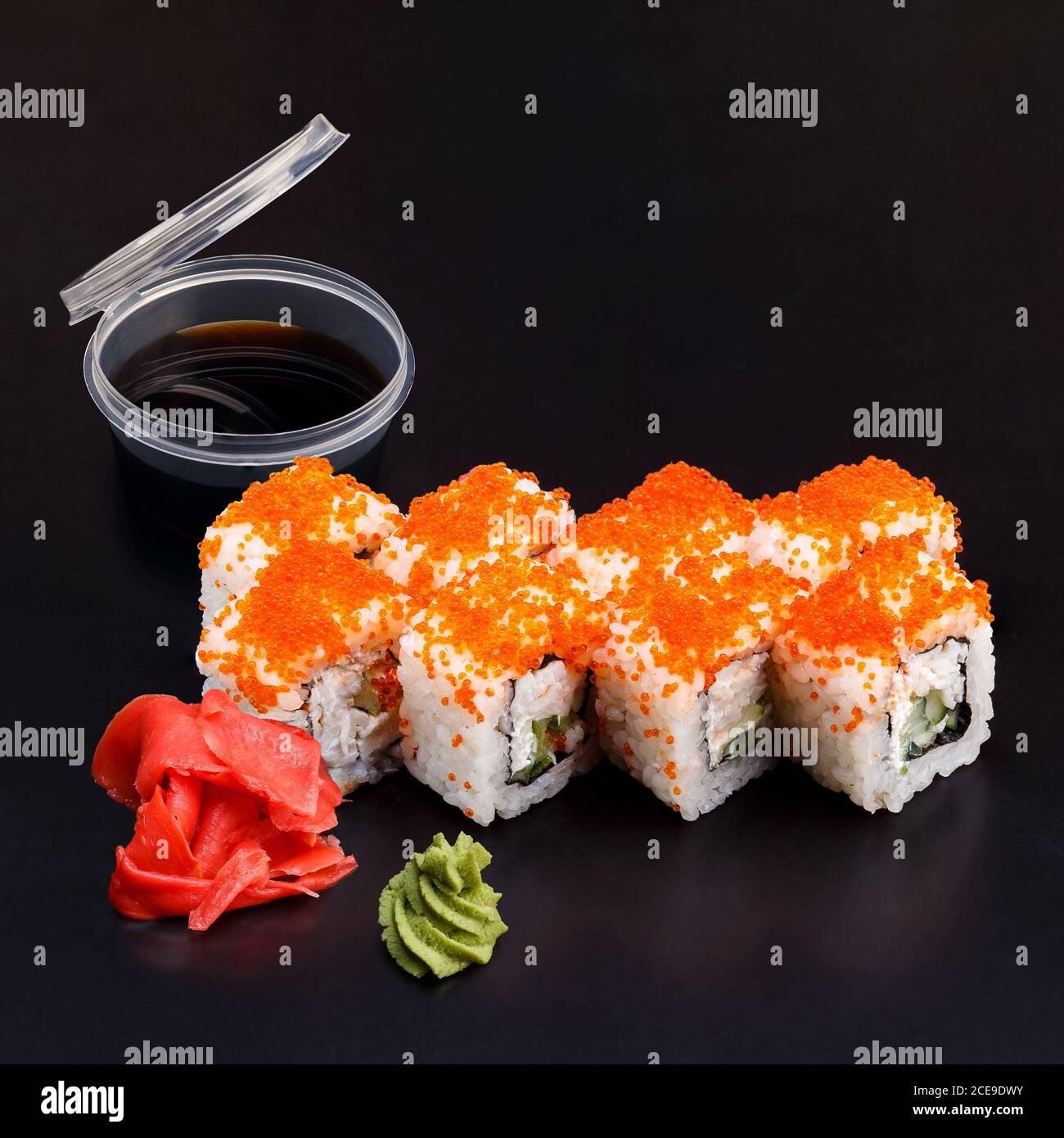 Traditional delicious fresh sushi roll set on a black background with ...