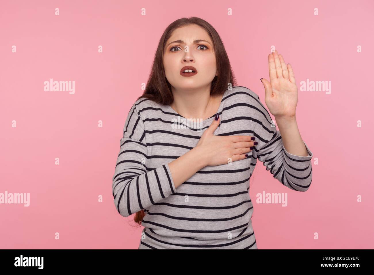 I swear! Portrait of very responsible and honest woman in striped ...